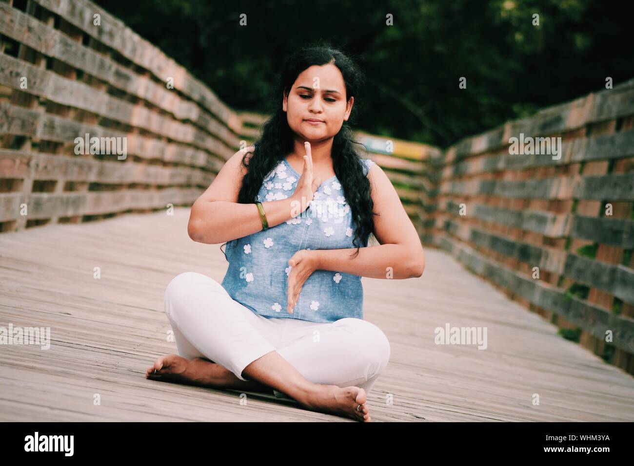 Person meditating sitting hi-res stock photography and images - Alamy