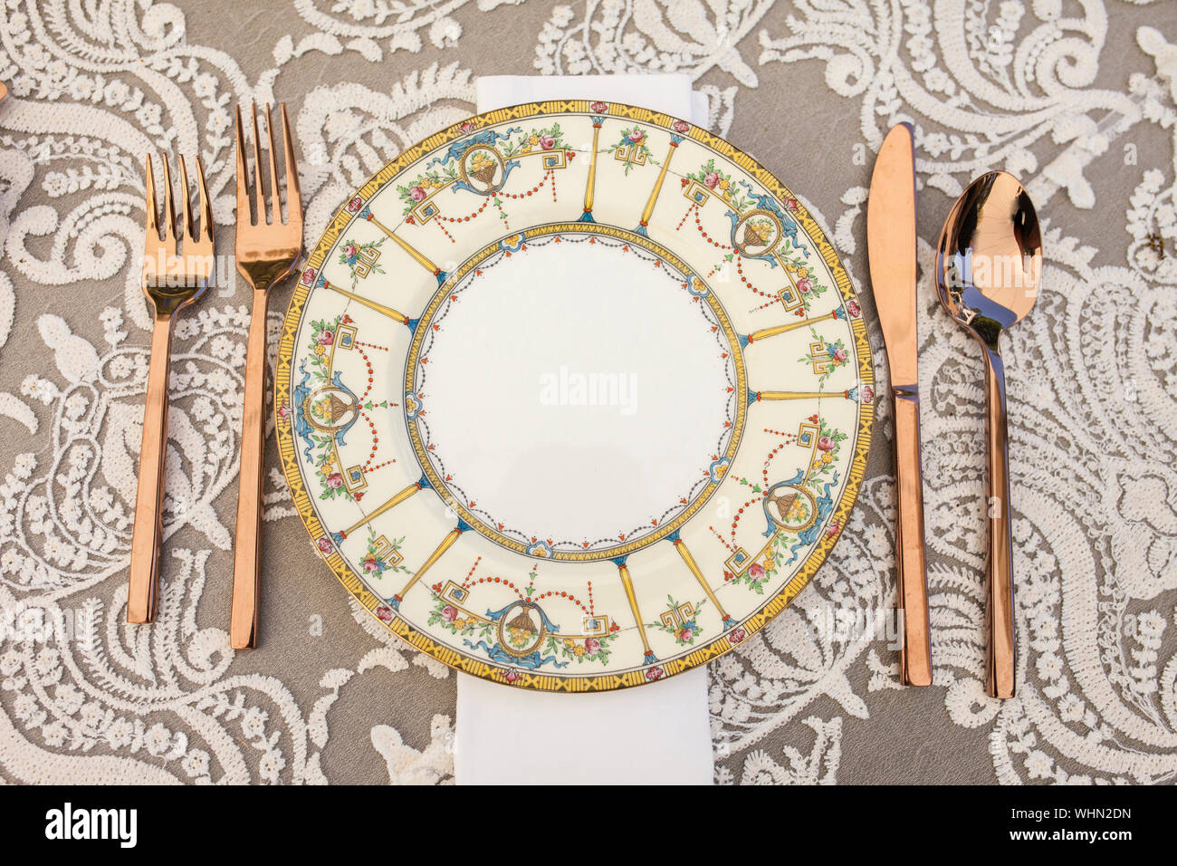 Vintage table setting with antique plate and silverware Stock Photo - Alamy