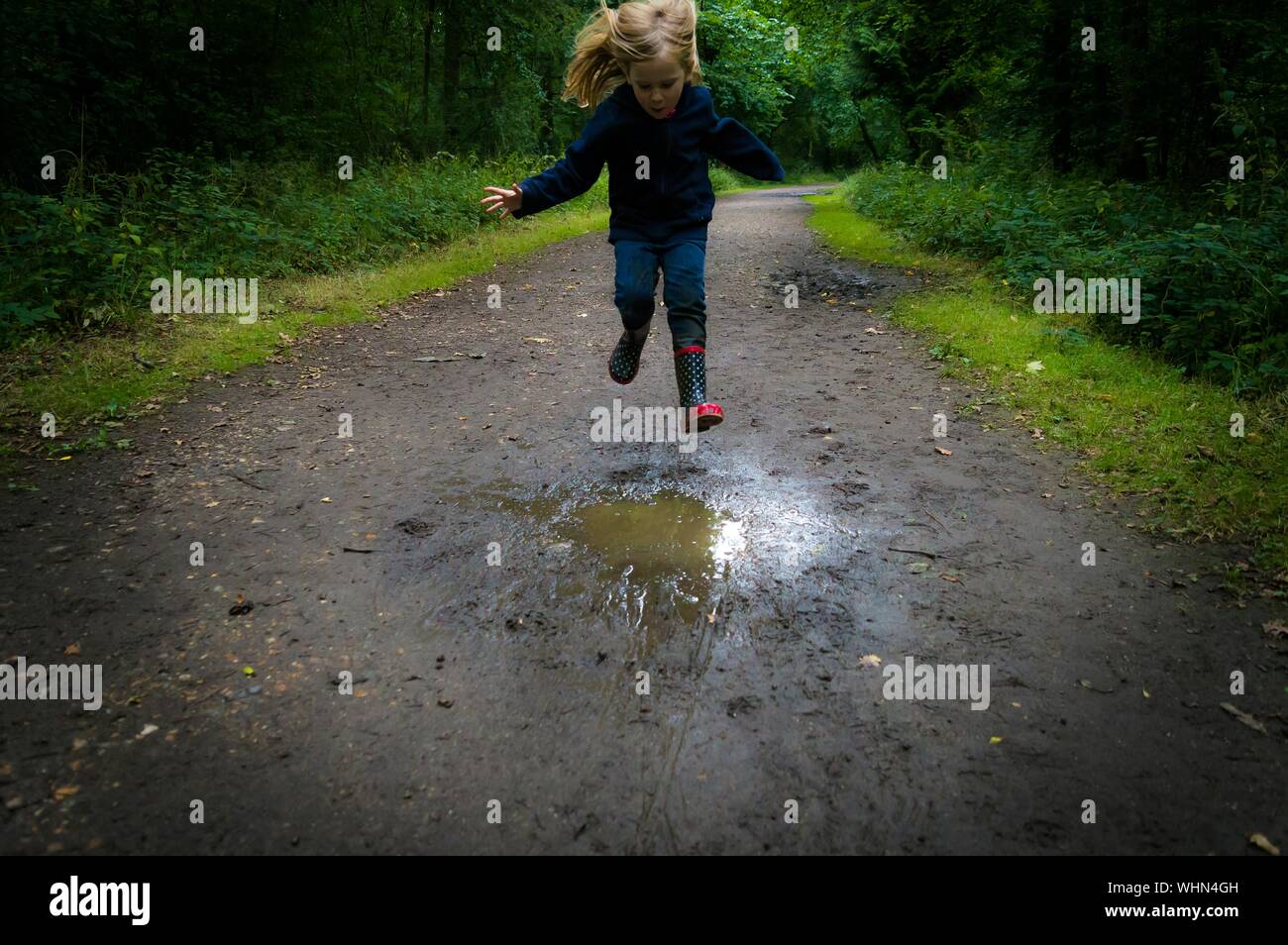 Jumping over puddle hi-res stock photography and images - Alamy