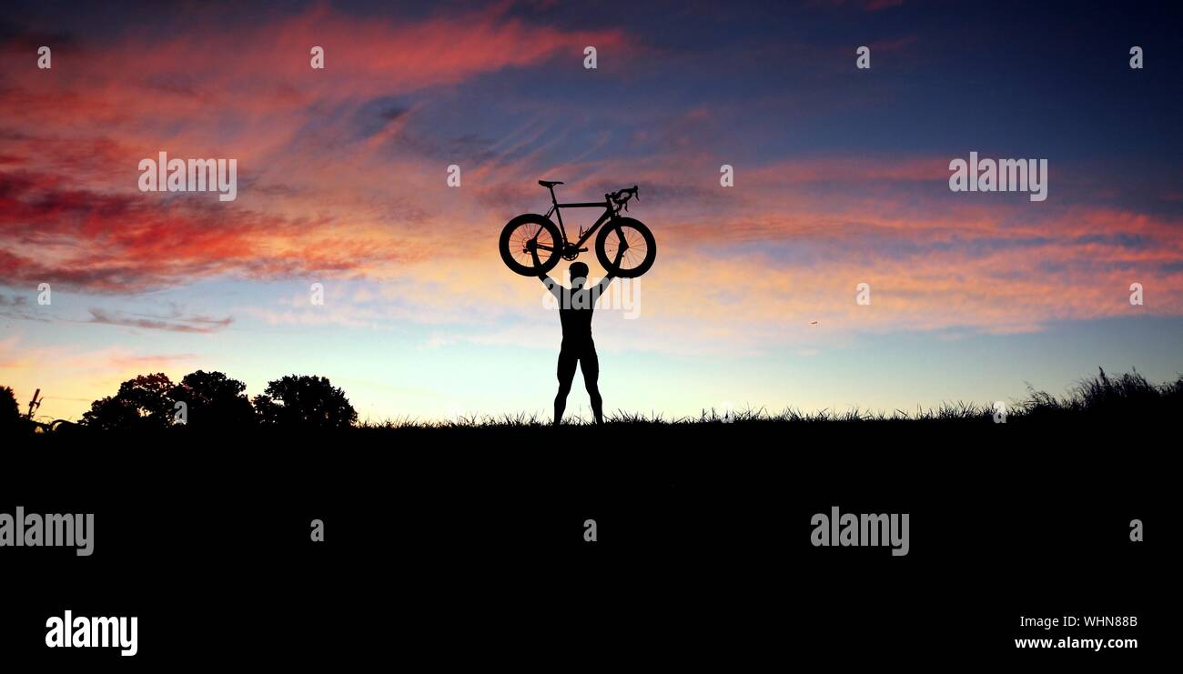 Man holding bike above head hi-res stock photography and images - Alamy