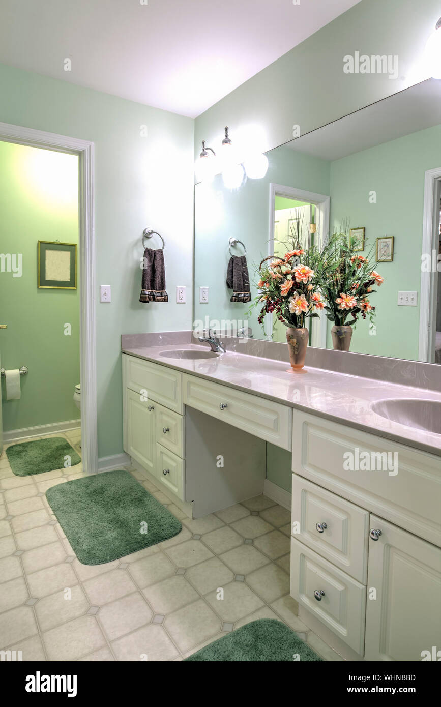 simple bathroom with double sinks and separate toilet Stock Photo - Alamy