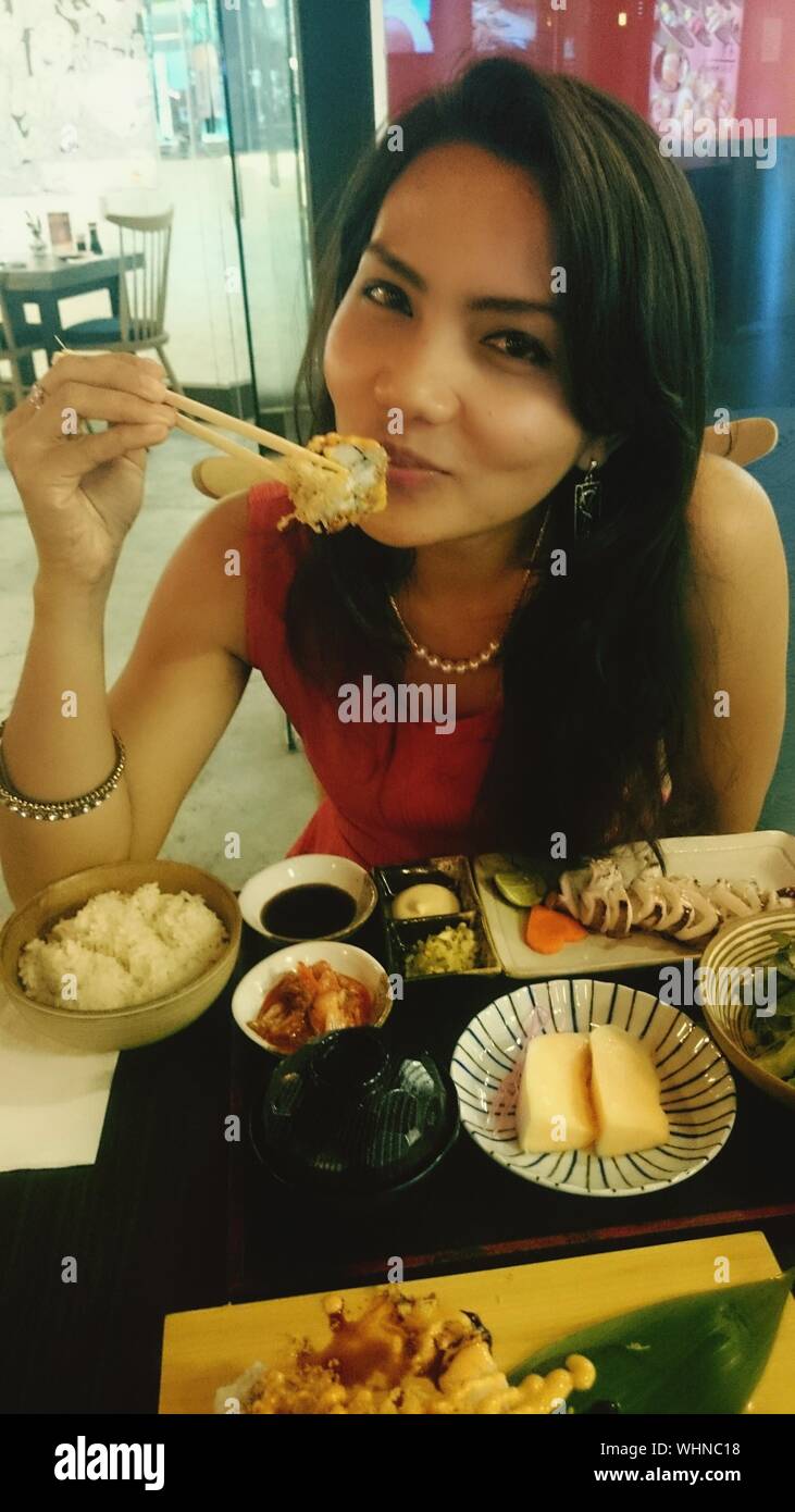 Young asian woman eating hi-res stock photography and images - Alamy