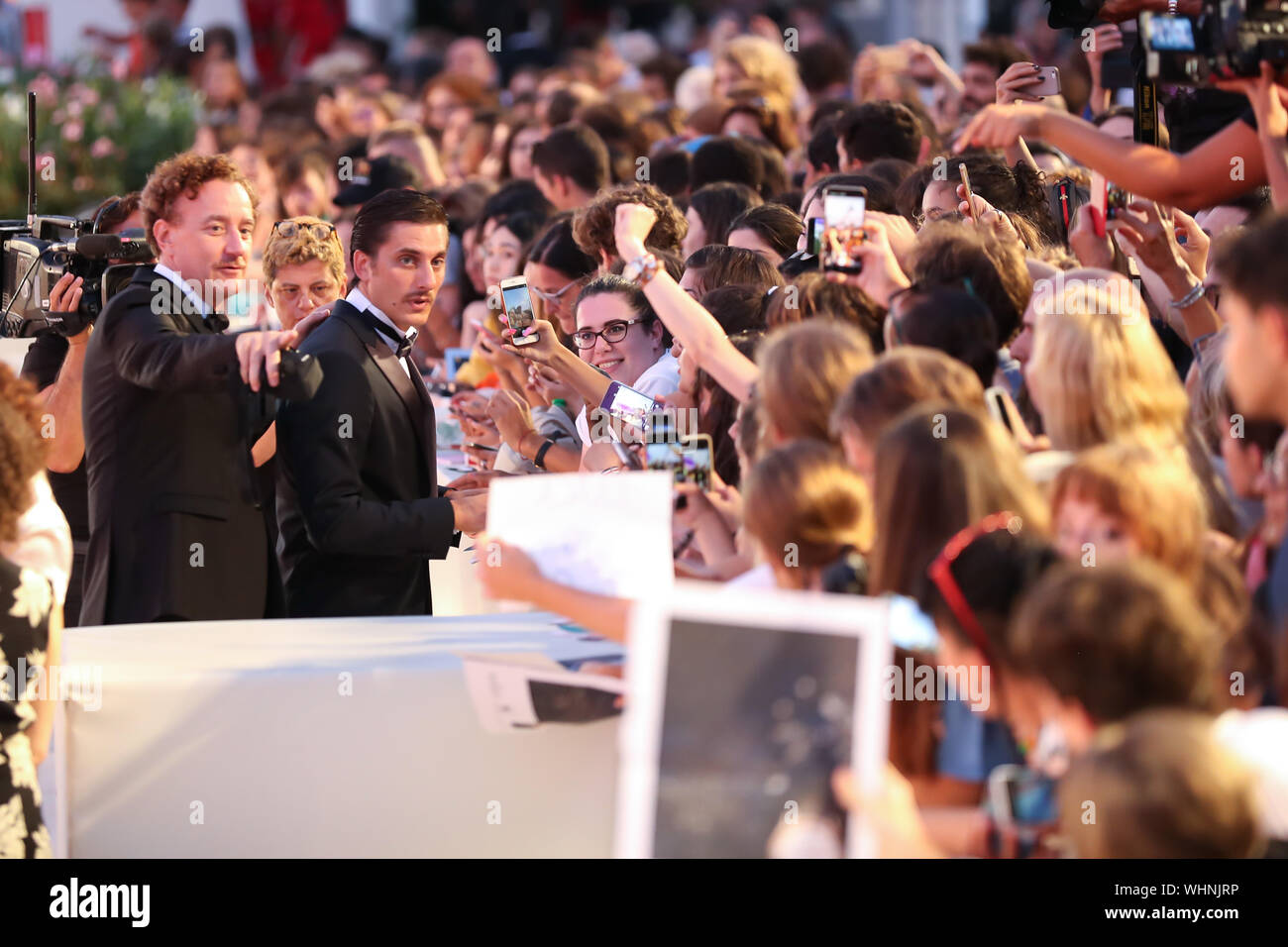 Venice, Italy. 2nd Sep, 2019. Actor Luca Marinelli (2nd L) interacts ...