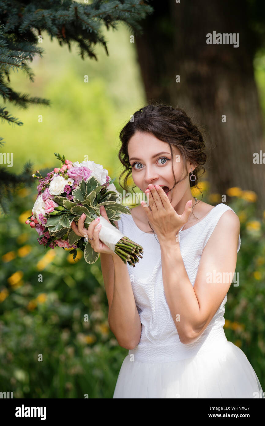 Young beautiful stylish wife. Bride bouquet. Graceful hairstyle, beauty ...