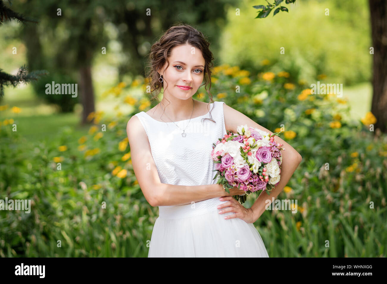 Beautiful bride in fashion wedding dress on natural background. The ...
