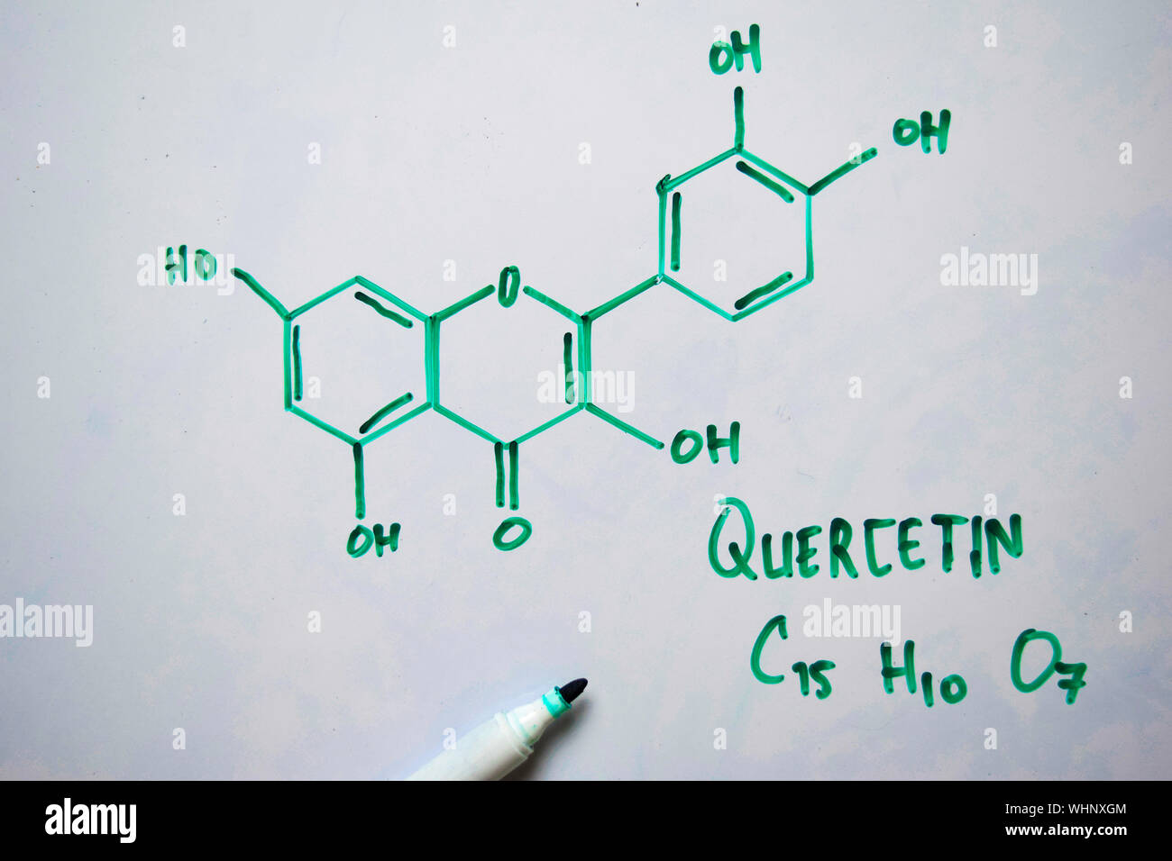 Quercetin (C15,H10,O7) molecule written on the white board. Structural ...