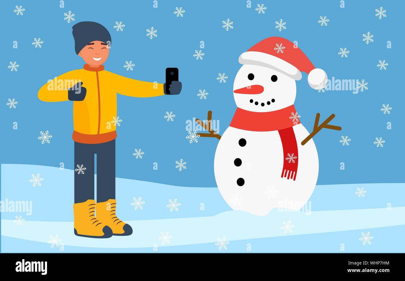 Happy man with a smartphone, takes a picture of a snowman on the ...