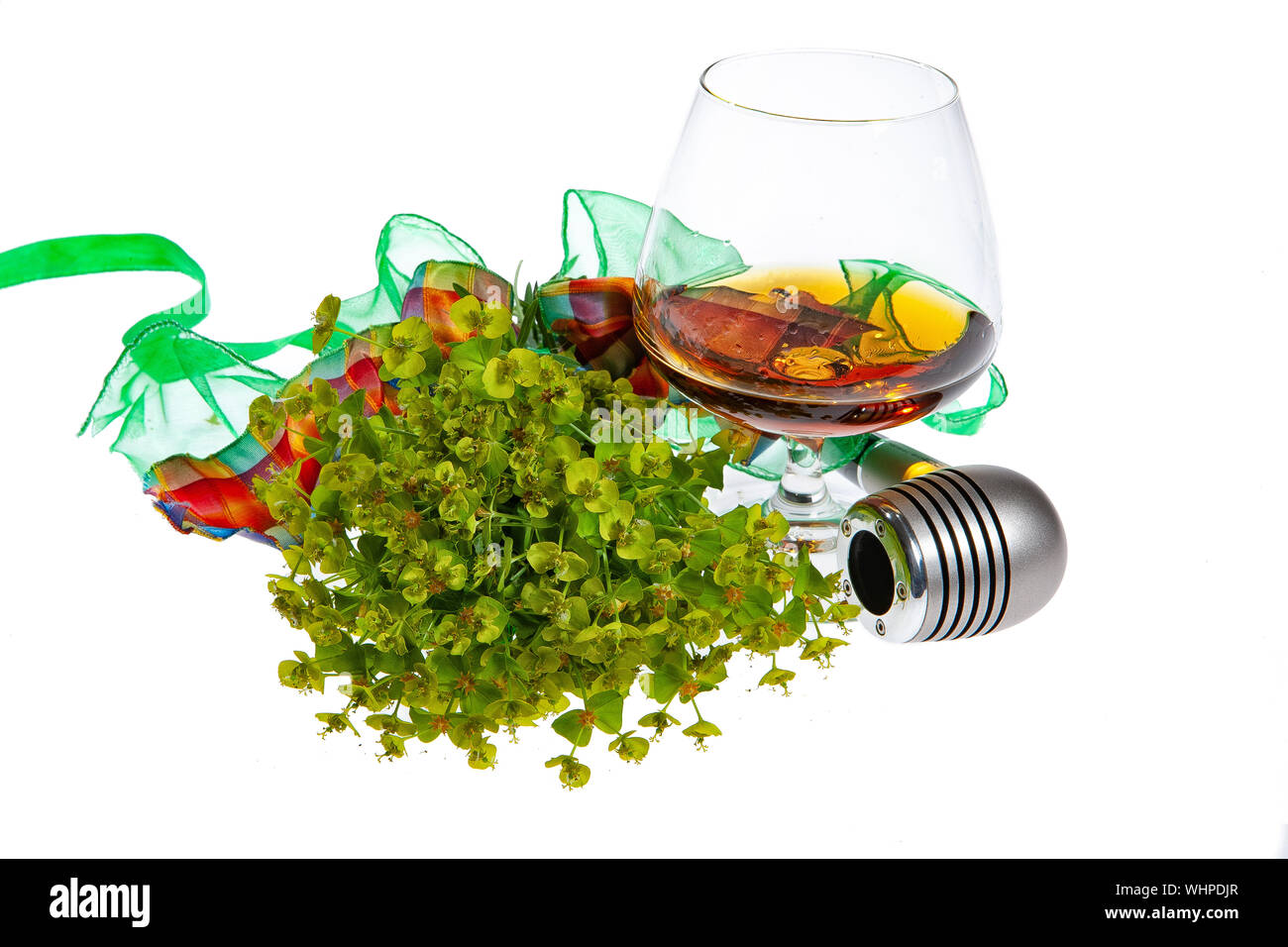 Glass with cognac on an isolated studio background Stock Photo - Alamy