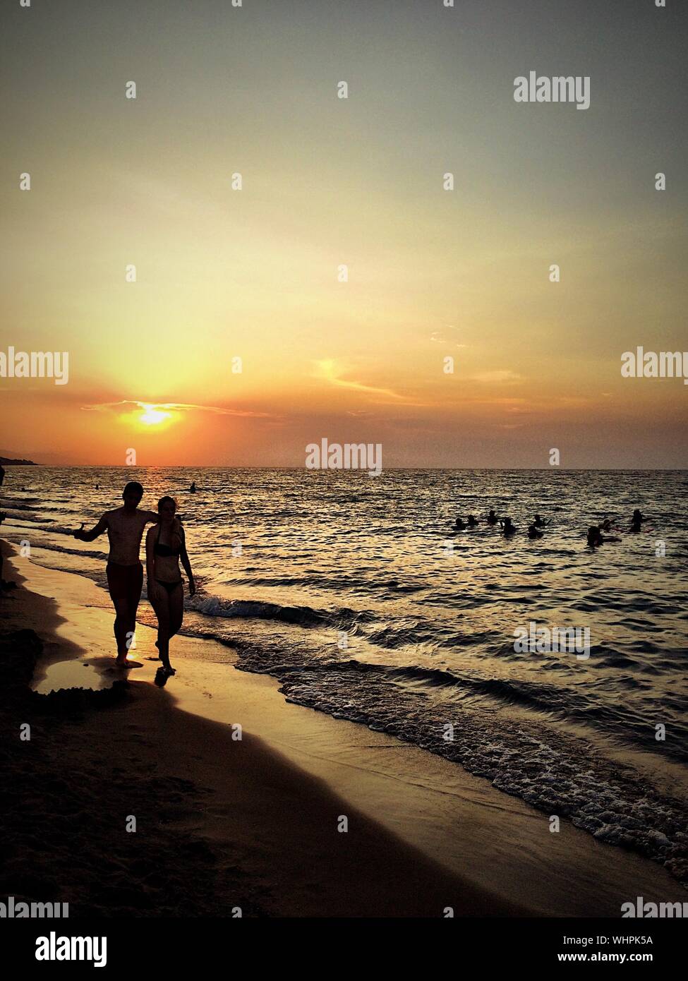 Man and woman walking into sunset hi-res stock photography and images ...