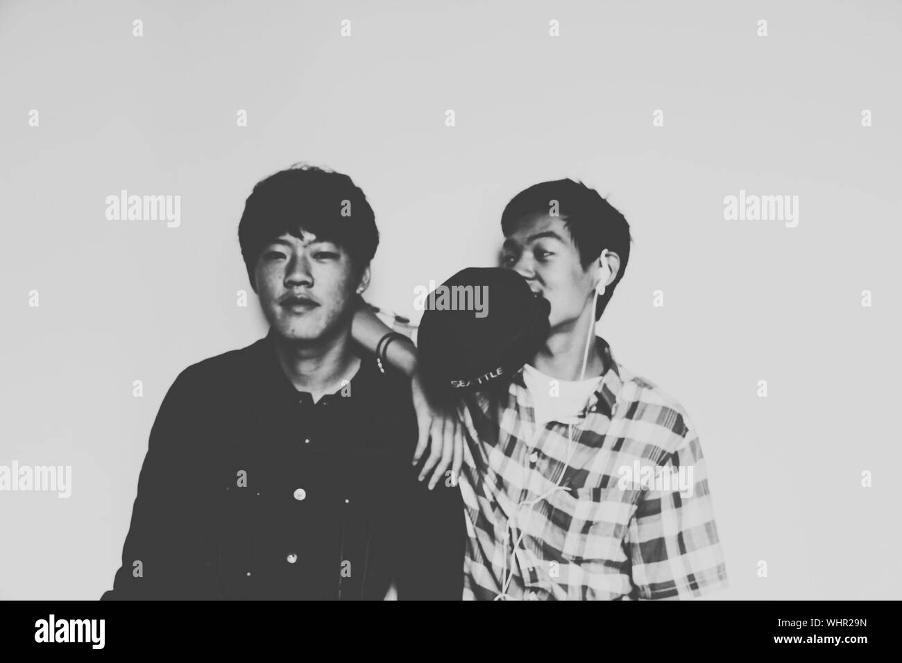 Friends Standing Against Wall Stock Photo - Alamy