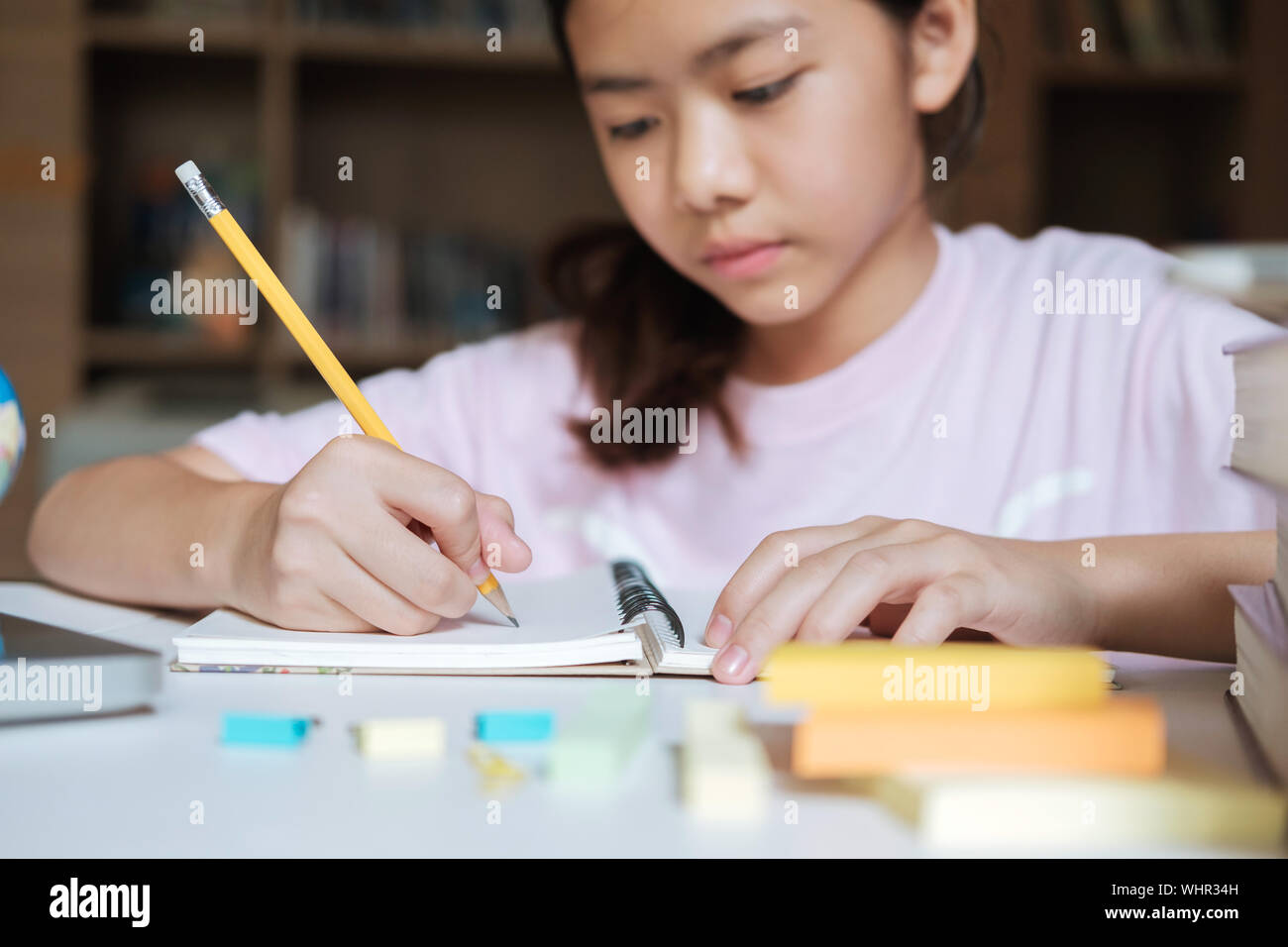 Sitting holding learning education writing hi-res stock photography and ...