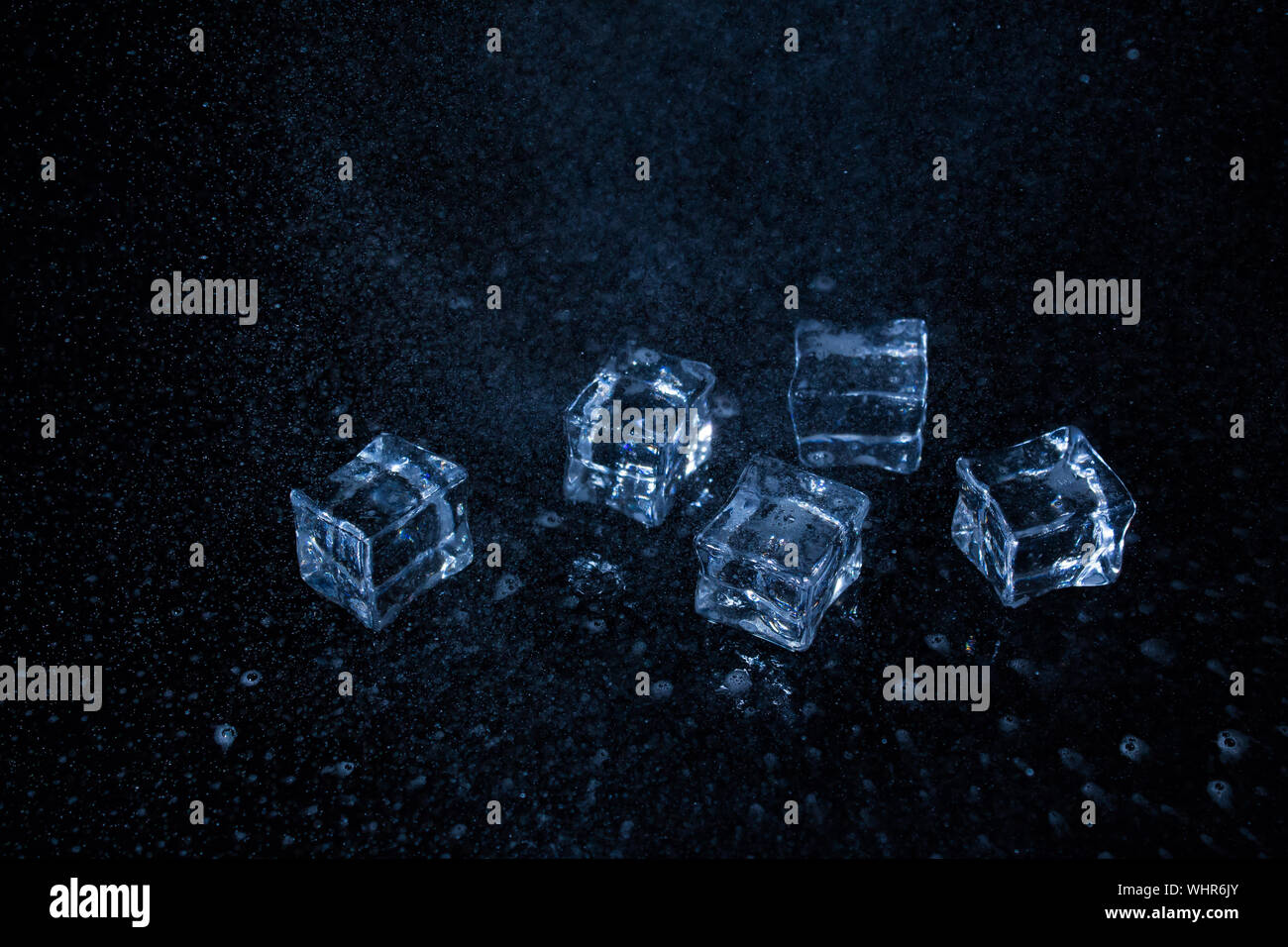 Ice cubes on a black background with splashes and water drops Stock ...