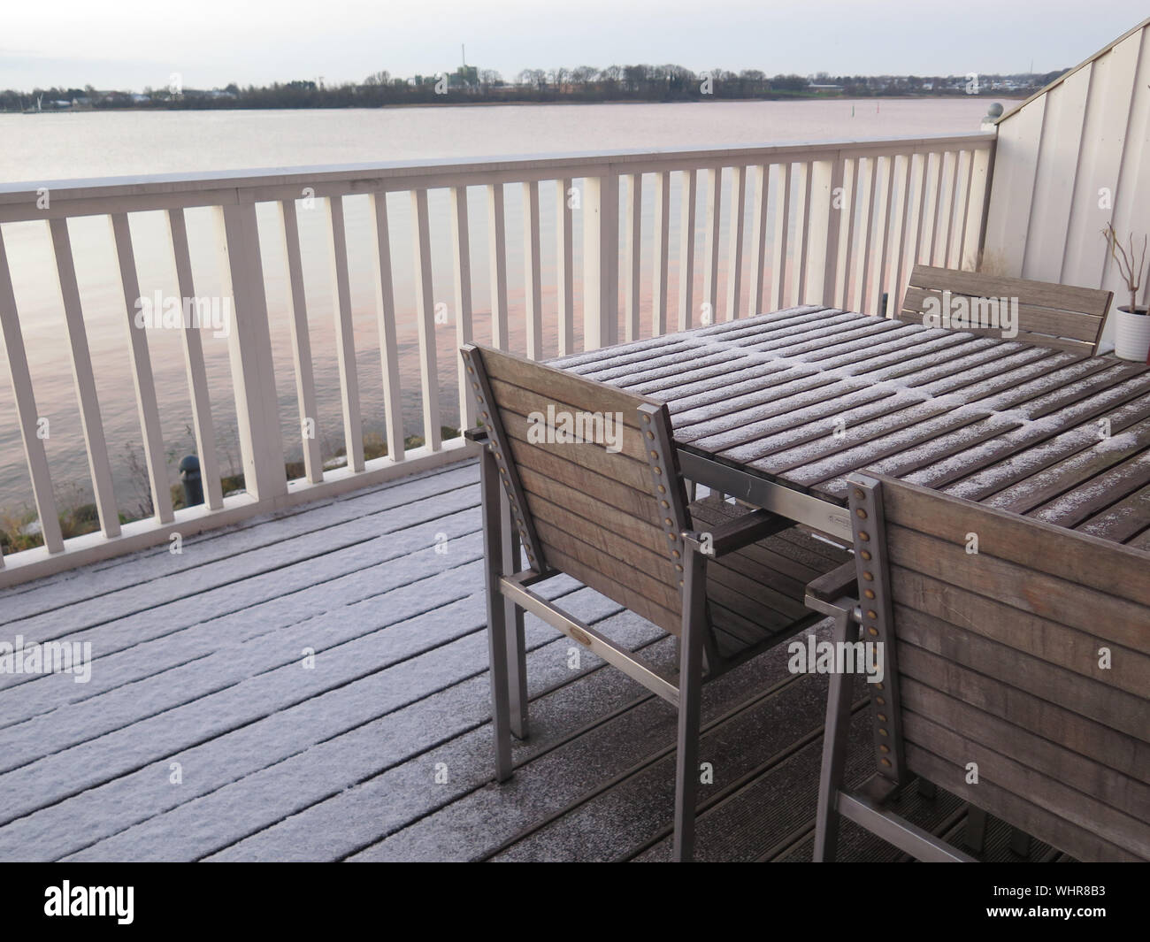 Snow covered wooden terrace by fjord in southern Denmark Stock Photo ...