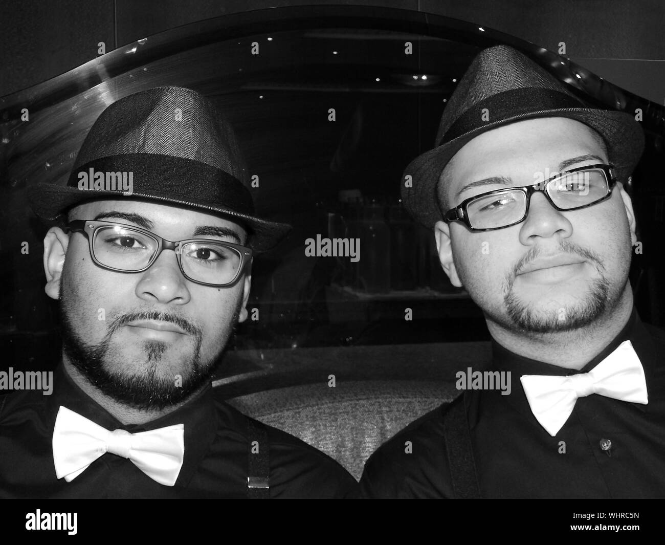 Two men wearing black hats Black and White Stock Photos & Images - Alamy