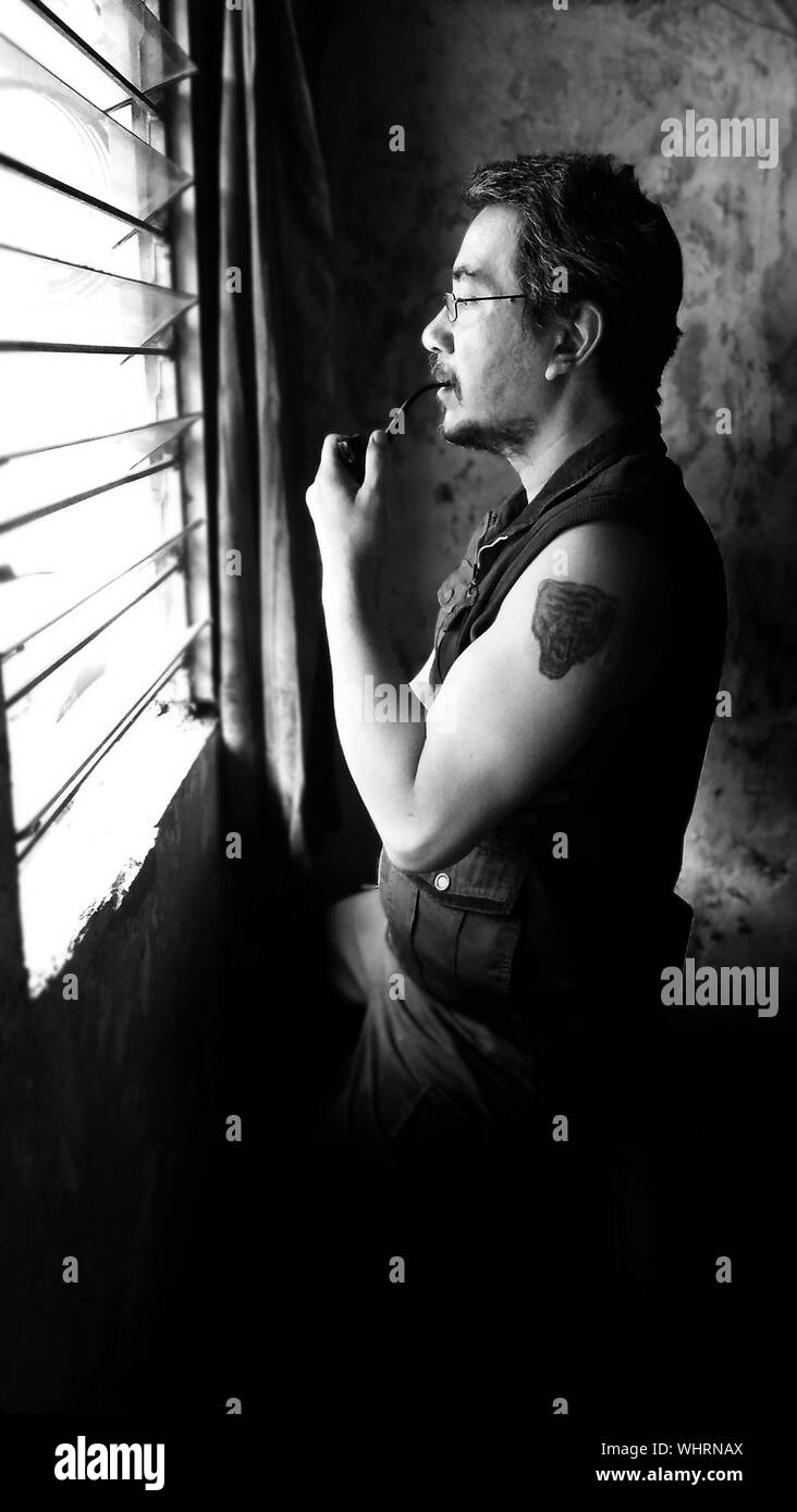 Smoking man at the window Black and White Stock Photos & Images - Alamy
