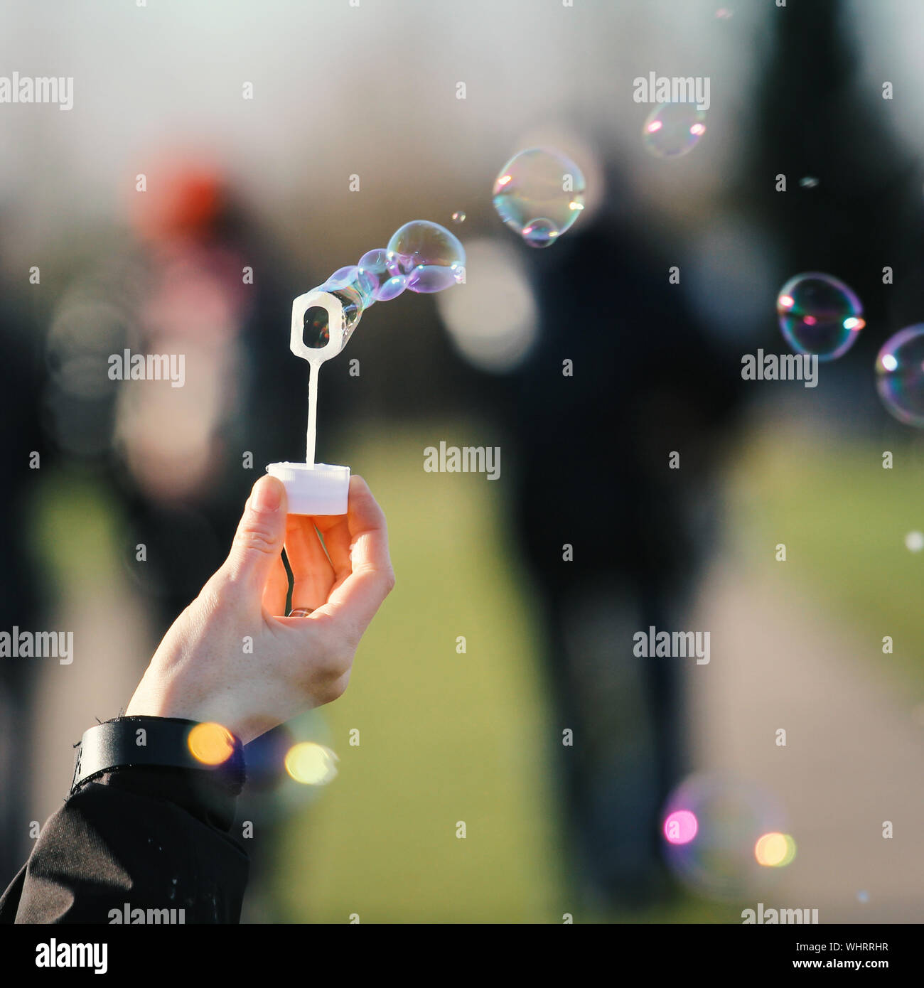 Hand holding bubble wand hi-res stock photography and images - Alamy