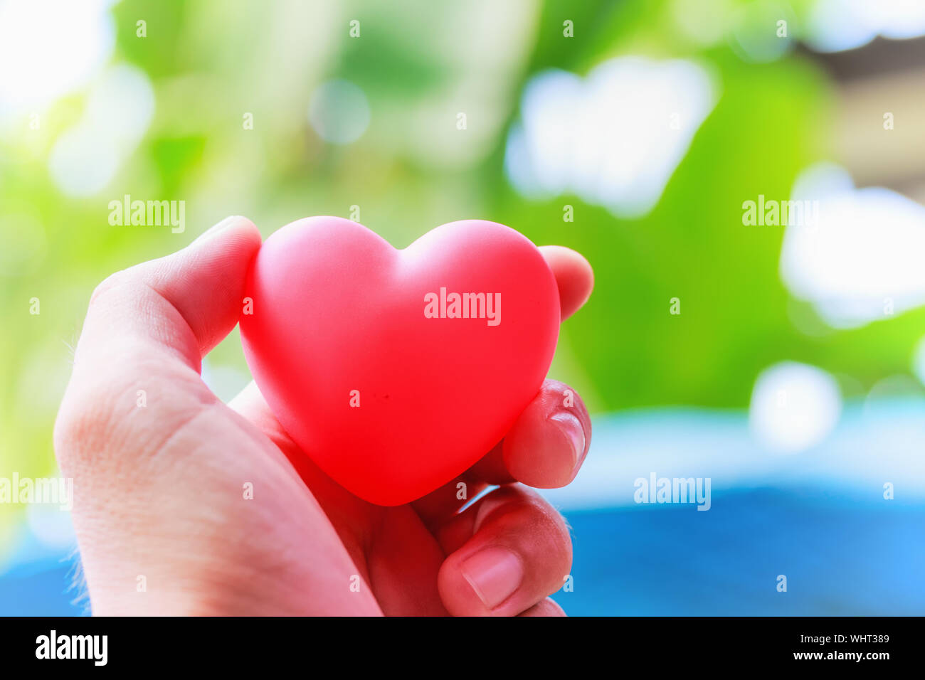 Hand holding heart shape balloon hi-res stock photography and images ...