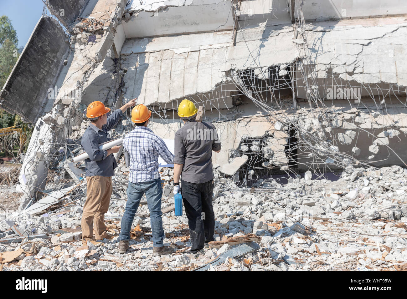 Engineer architect and worker operation control demolish old building ...