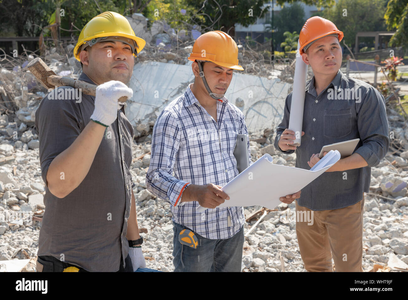 Engineer architect and worker operation control demolish old building ...