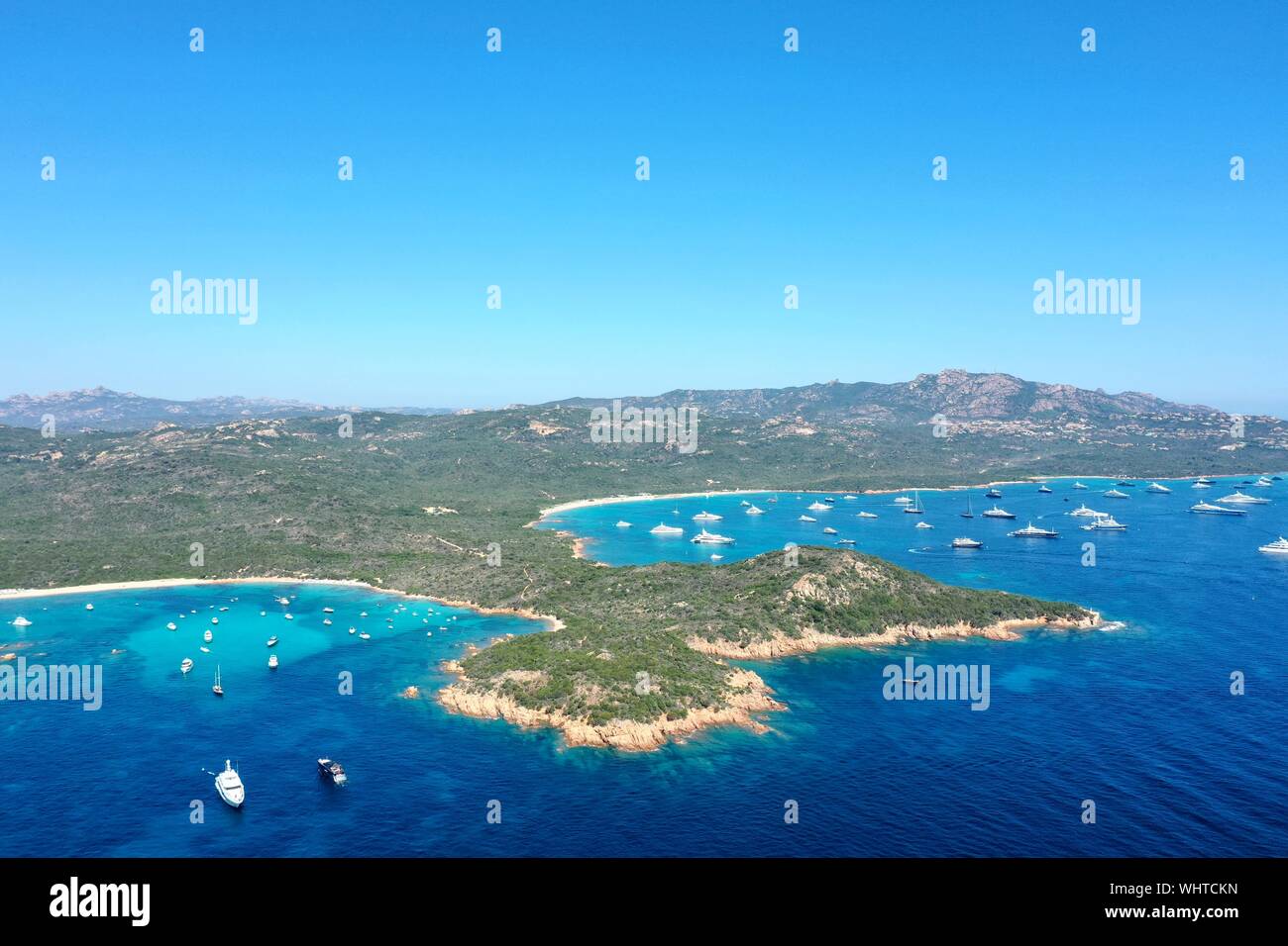 View from above, stunning aerial view of a beautiful bay full of boats ...