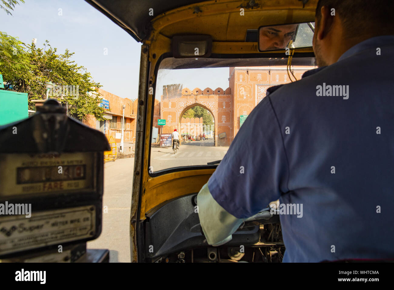 A rickshaw (also known as Tuc Tuc) driver is driving on the streets of ...
