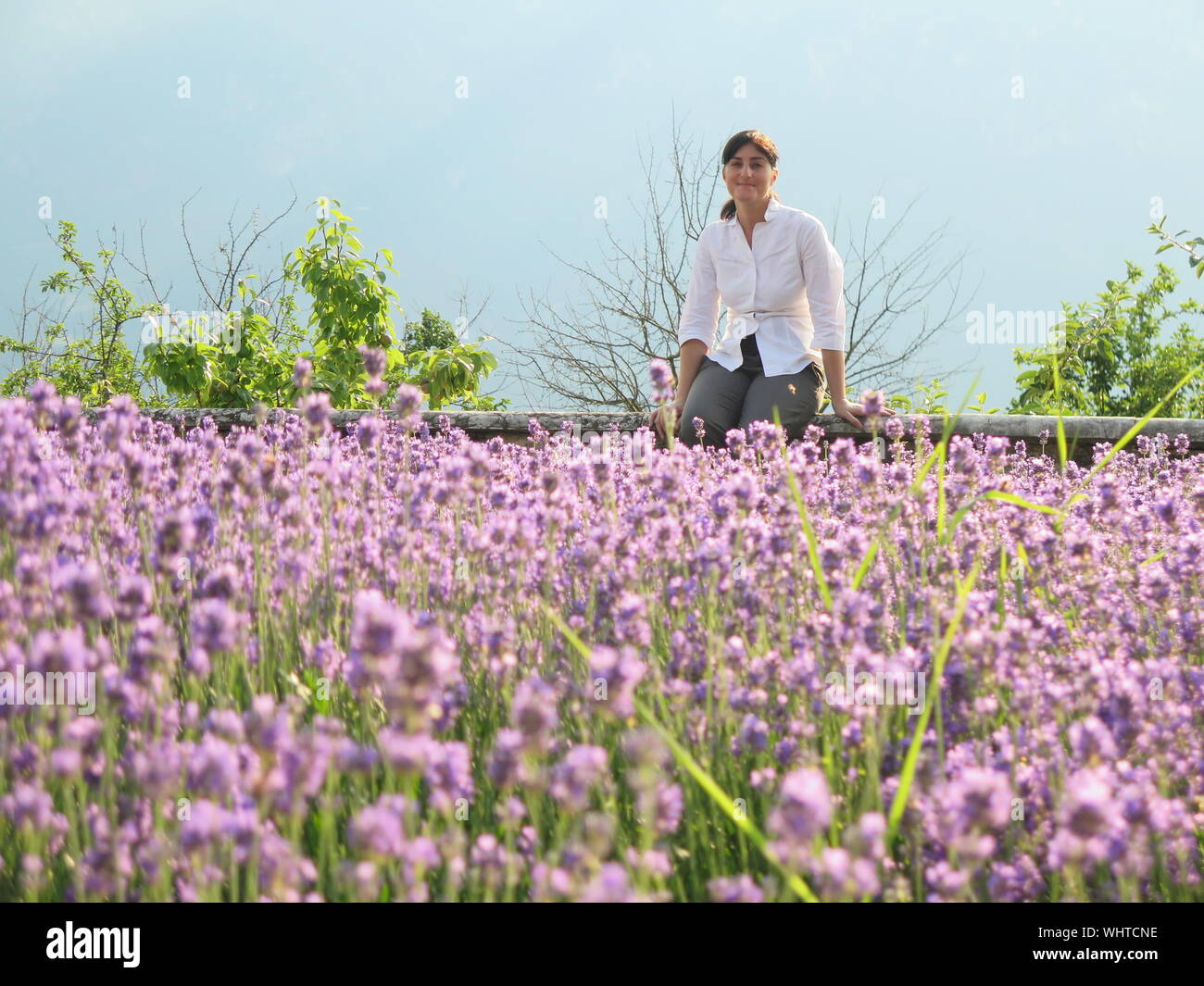 Women sitting in flower field hi-res stock photography and images - Alamy