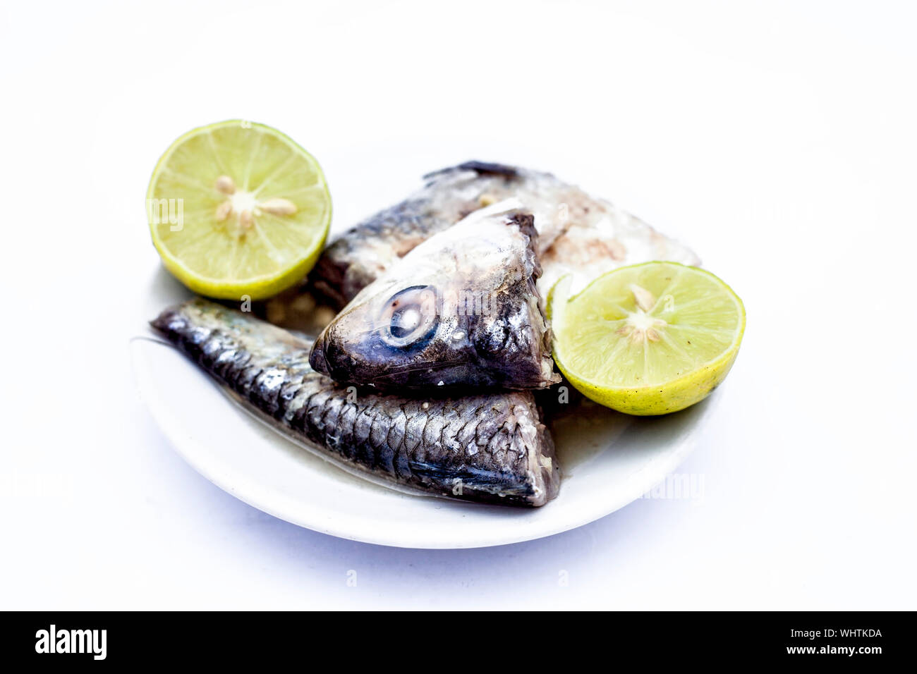 Marinated fish with lime or lemon juice in a glass plate isolated on ...