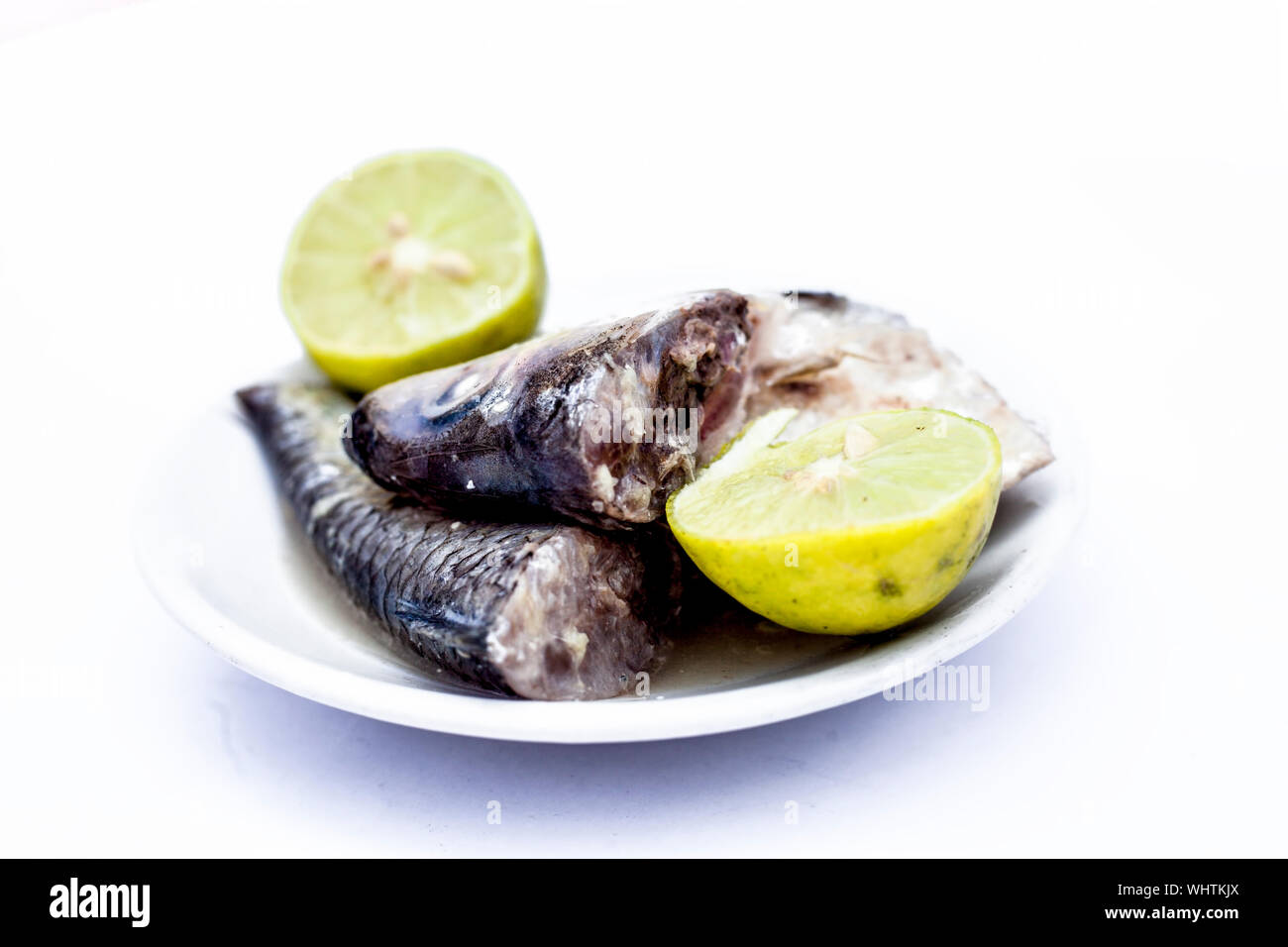 Marinated fish with lime or lemon juice in a glass plate isolated on ...