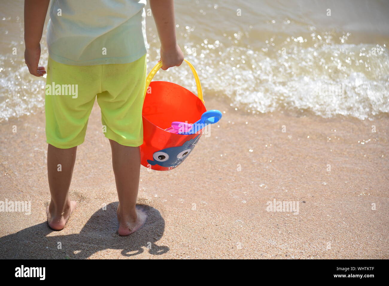 Boy standing on bucket hi-res stock photography and images - Alamy