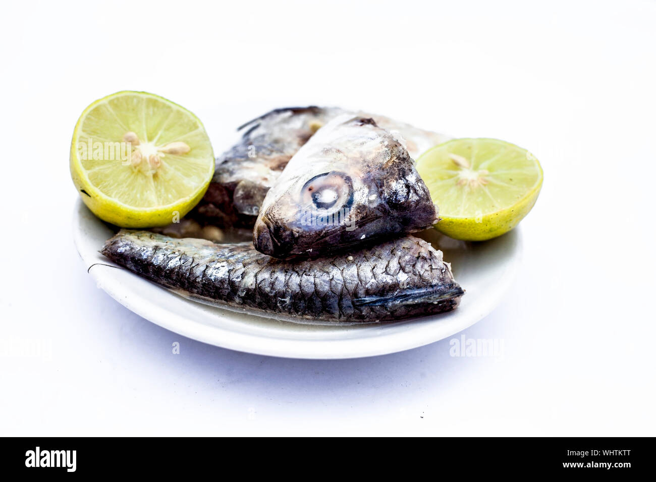 Marinated fish with lime or lemon juice in a glass plate isolated on ...