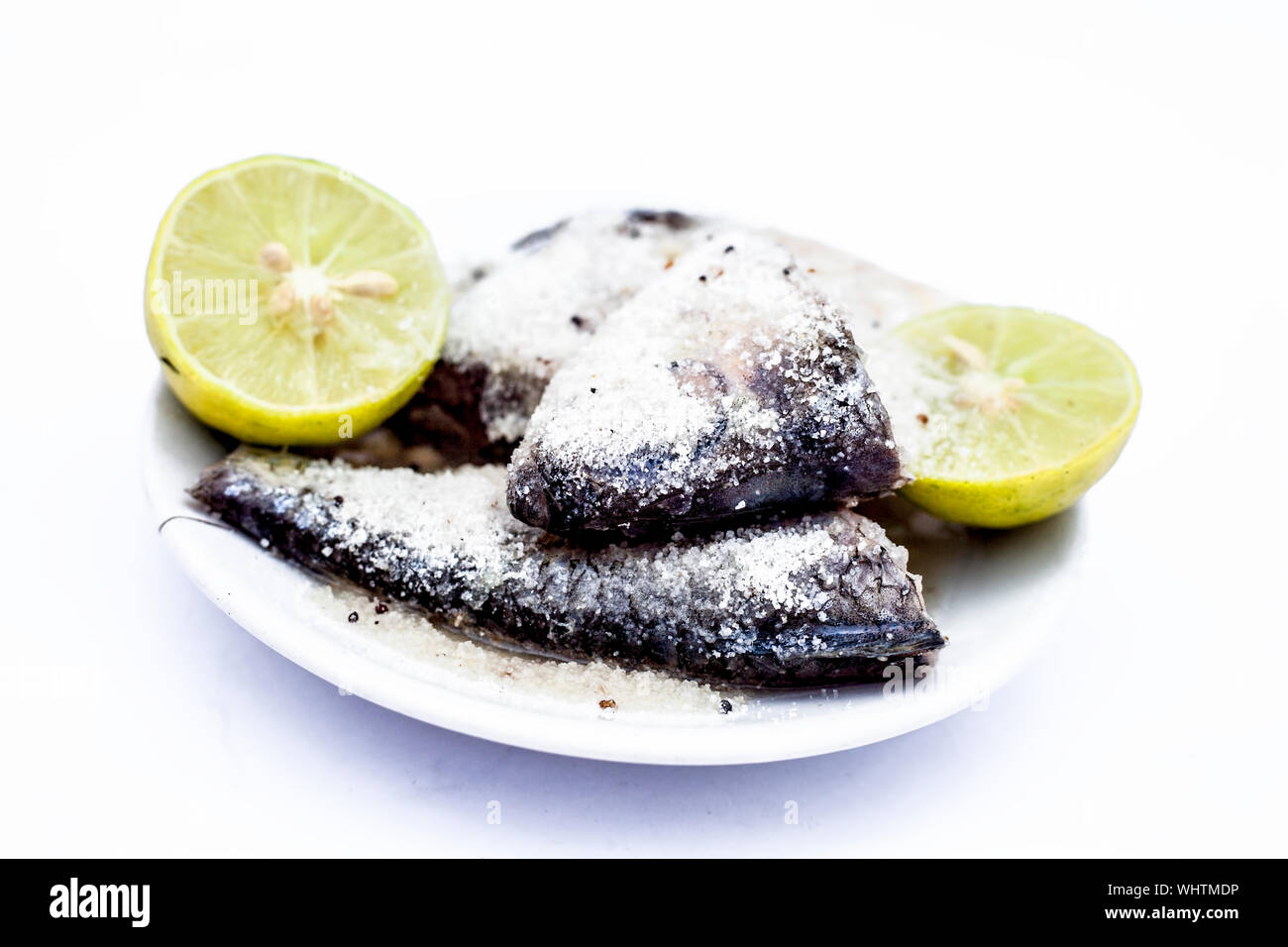 Marinated fish with lime or lemon juice in a glass plate isolated on ...