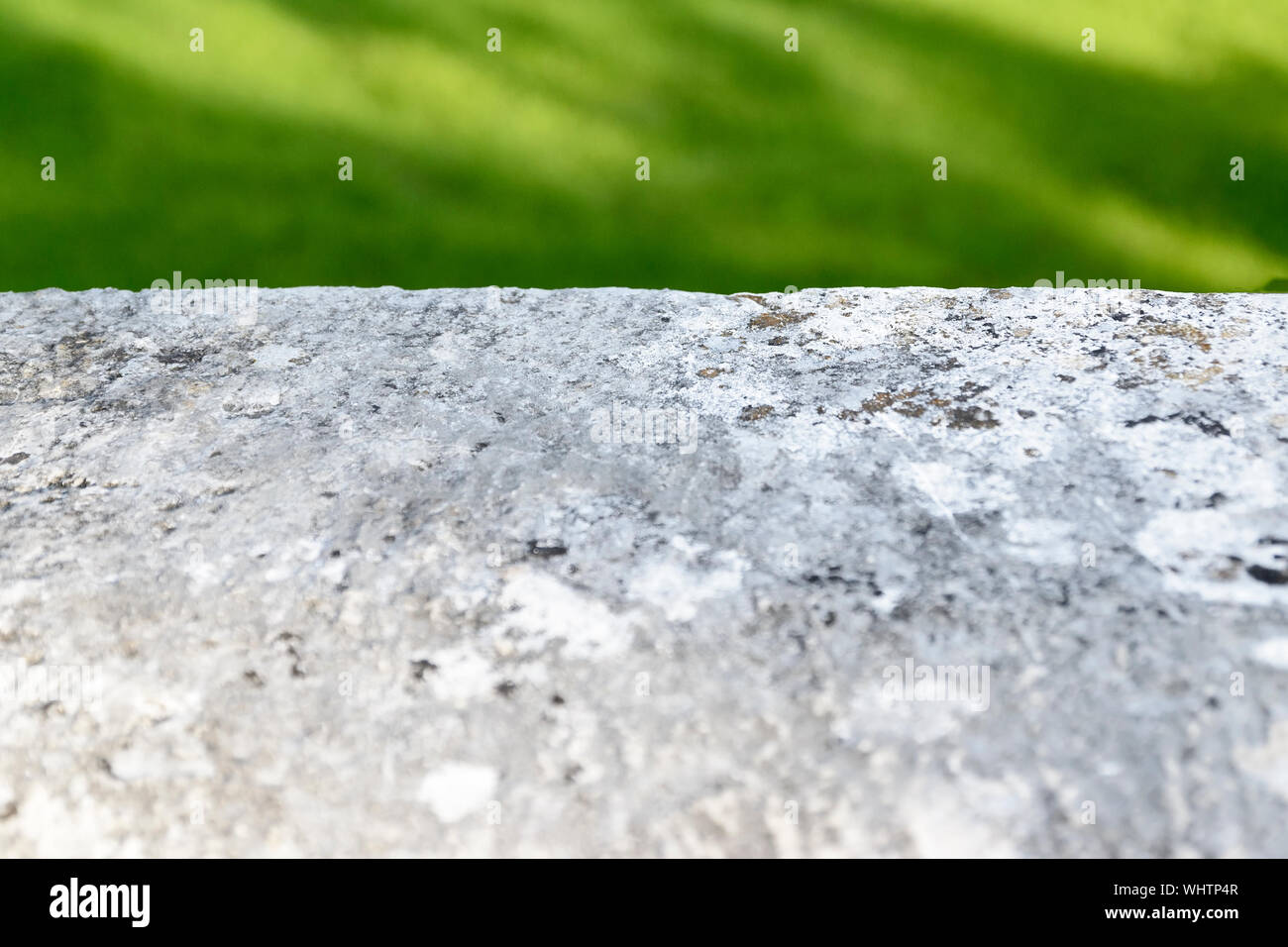 Light flat surface of stone on blurred grass background Stock Photo - Alamy