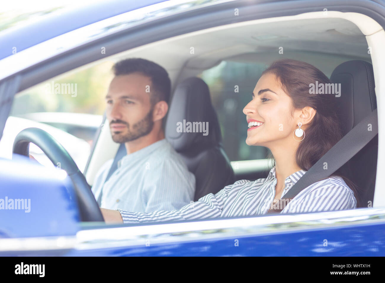 Appealing wife driving car and speaking with husband Stock Photo - Alamy