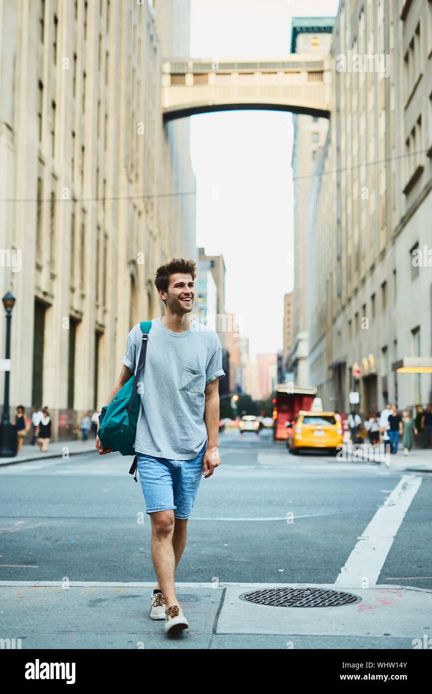 Young man walking the city hi-res stock photography and images - Alamy