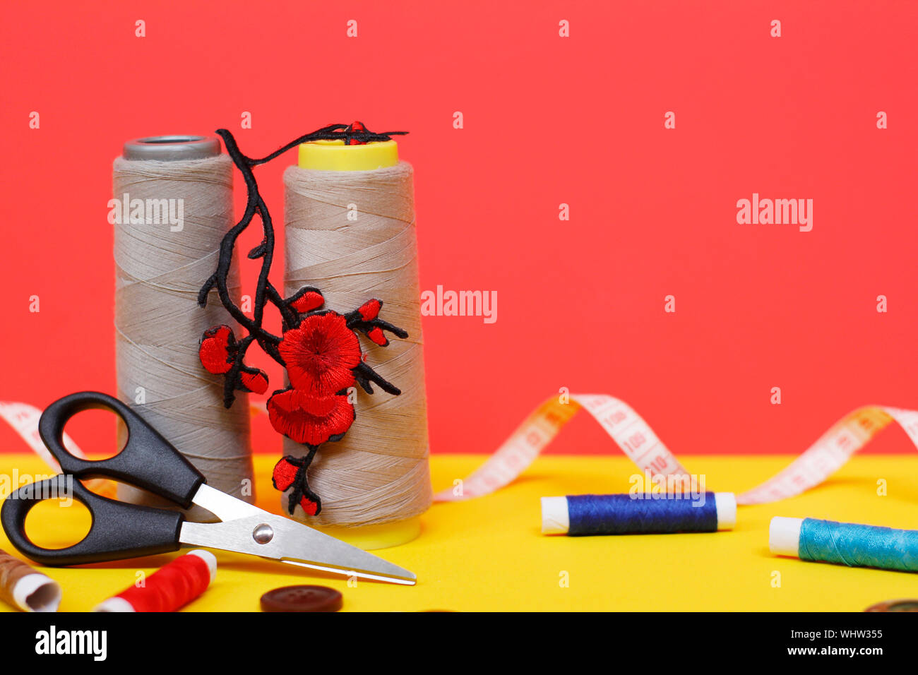 Two large spools of thread are standing, many small spools are lying ...