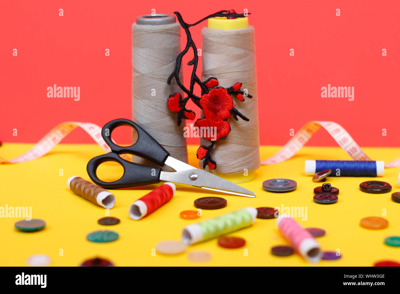 Two large spools of thread are standing, many small spools are lying ...