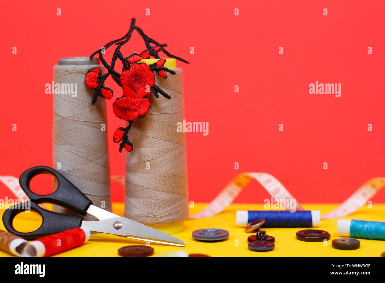 Two large spools of thread are standing, many small spools are lying ...