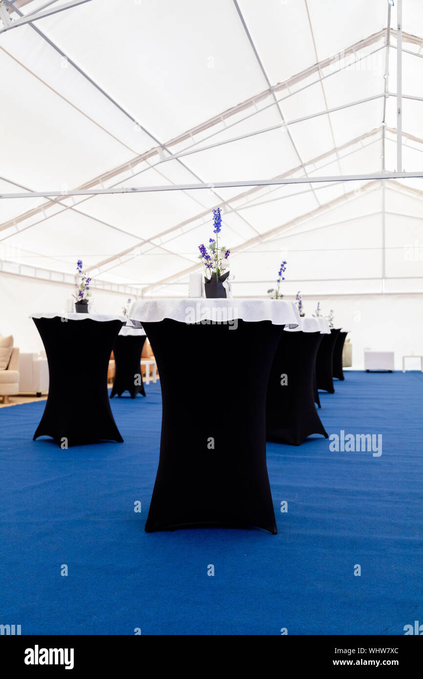 Catering, high buffet tables with a black and white tablecloth in lobby ...