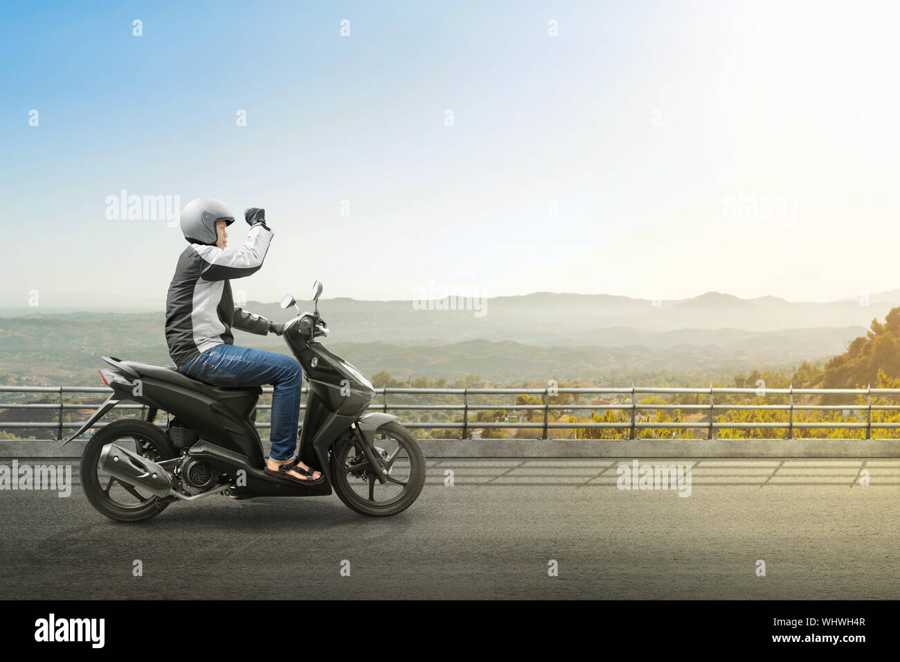 Asian motorcycle taxi man with his motorcycle on the asphalt road Stock ...