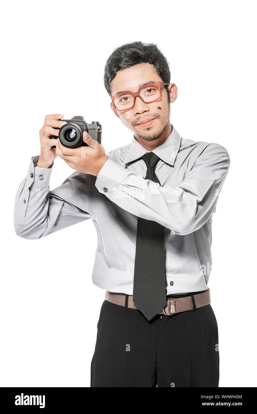 Asian businessman holding the camera on his hand standing isolated over ...