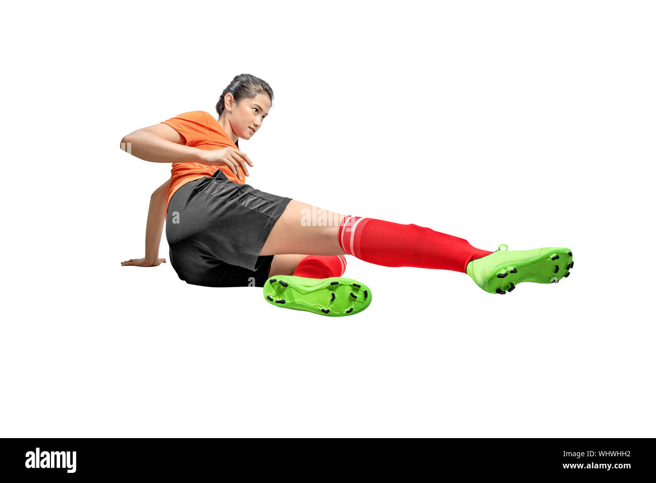 Asian football player woman on sliding tackle position isolated over ...