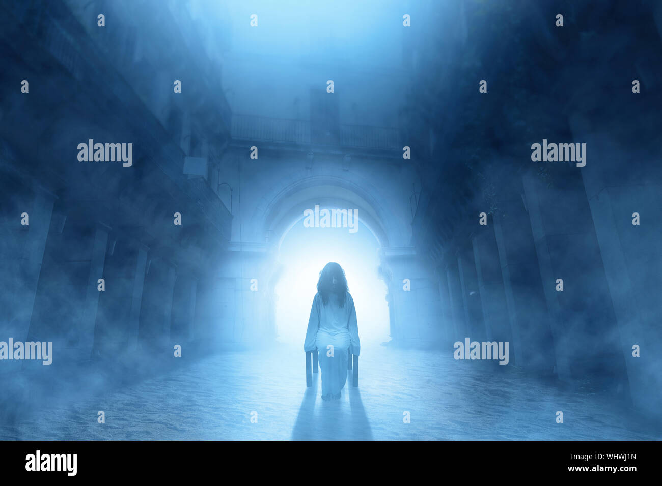 Scary ghost woman with blood and dirty face sitting on the abandoned ...