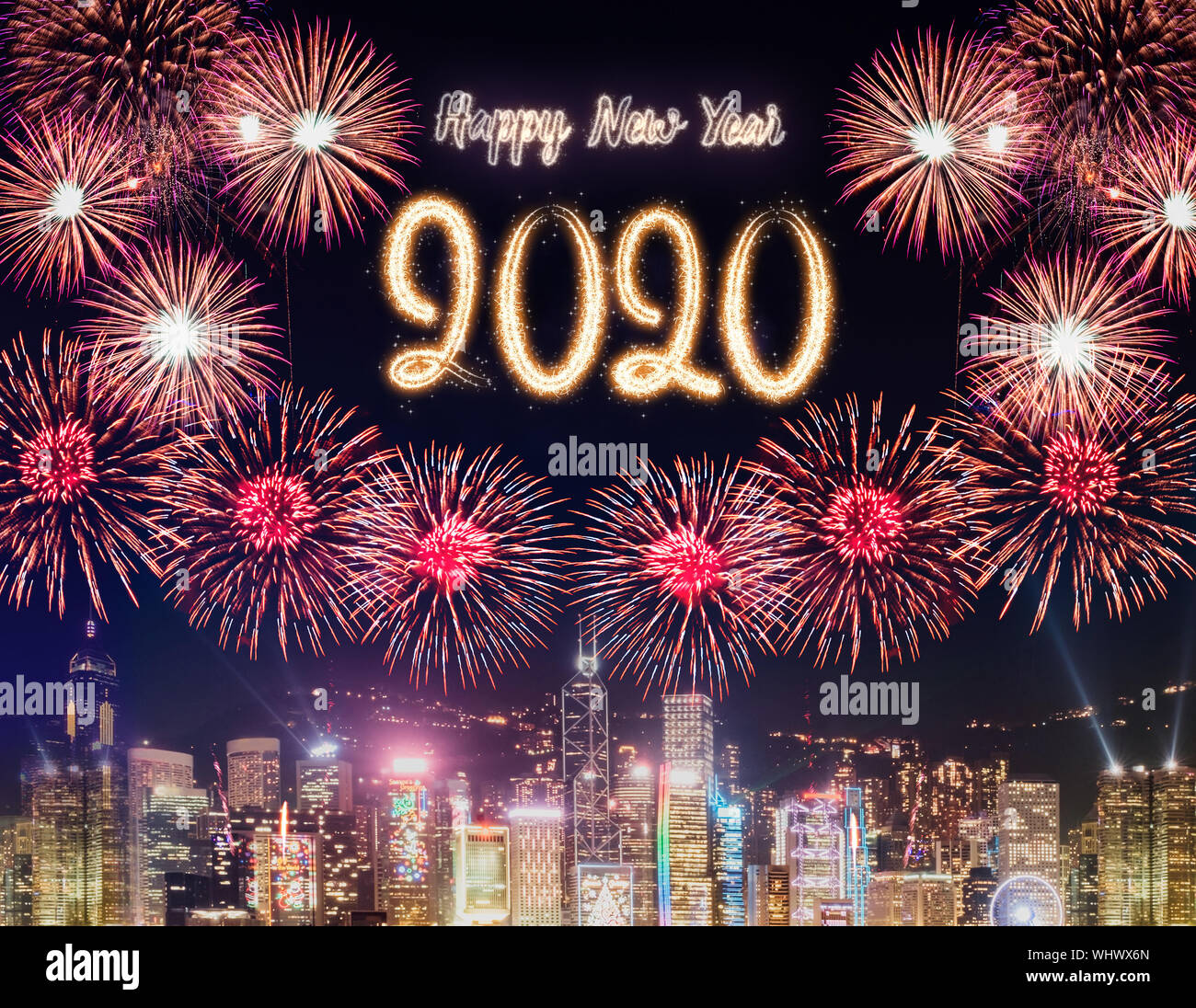 Happy new year 2020 firework over cityscape building near sea at night ...