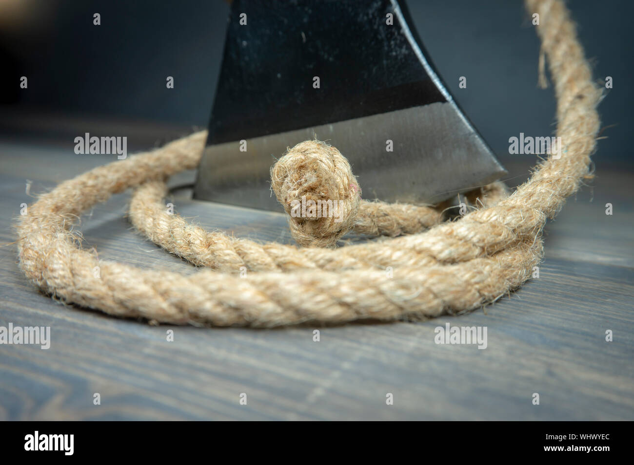 Metal axe or hatchet tool cutting natural jute rope. To cut the Gordian ...