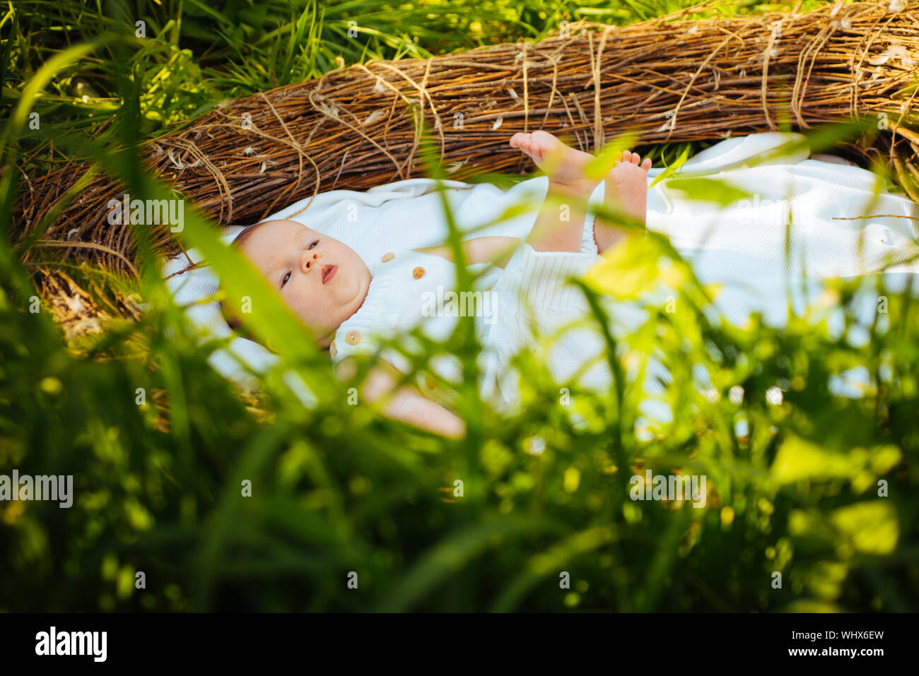 Obstetrics and gynecology. Newborn baby girl or boy awake in crib ...