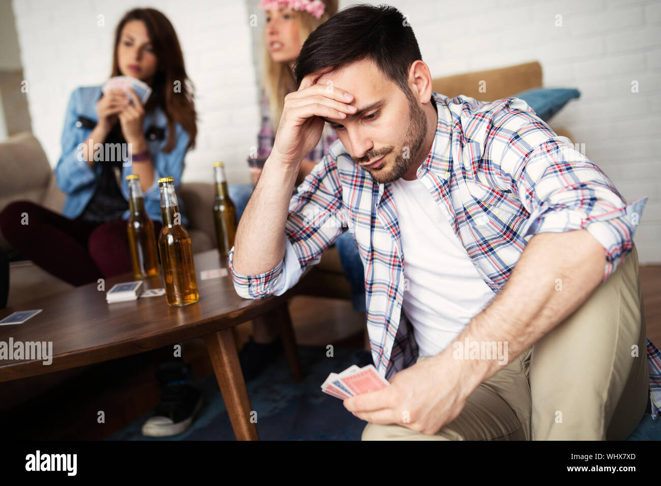 Game, unlucky and fail concept. Losing sad man playing cards with ...