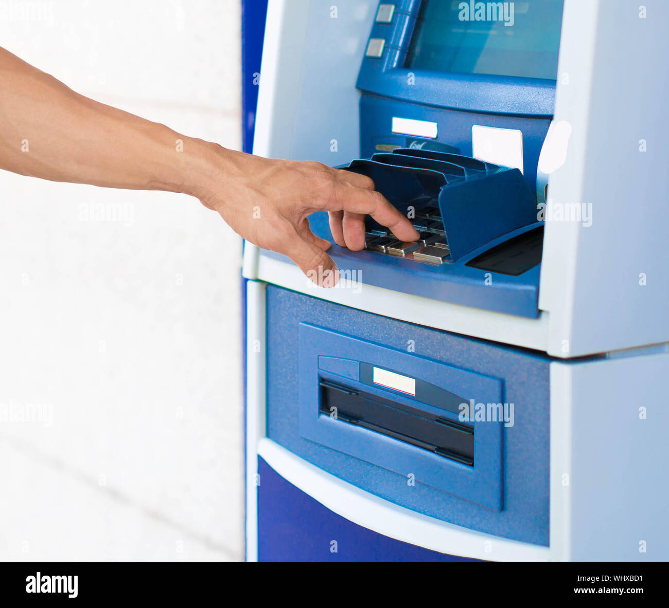 Blue ATM machine. Closesup of hand pushing buttons Stock Photo - Alamy