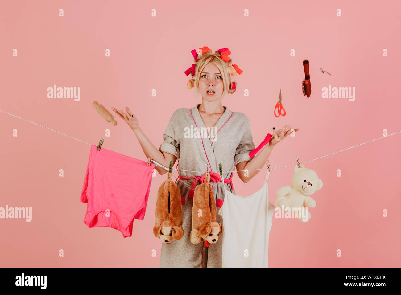 Busy mother. Multitasking mom. Performing Different Household Duties ...