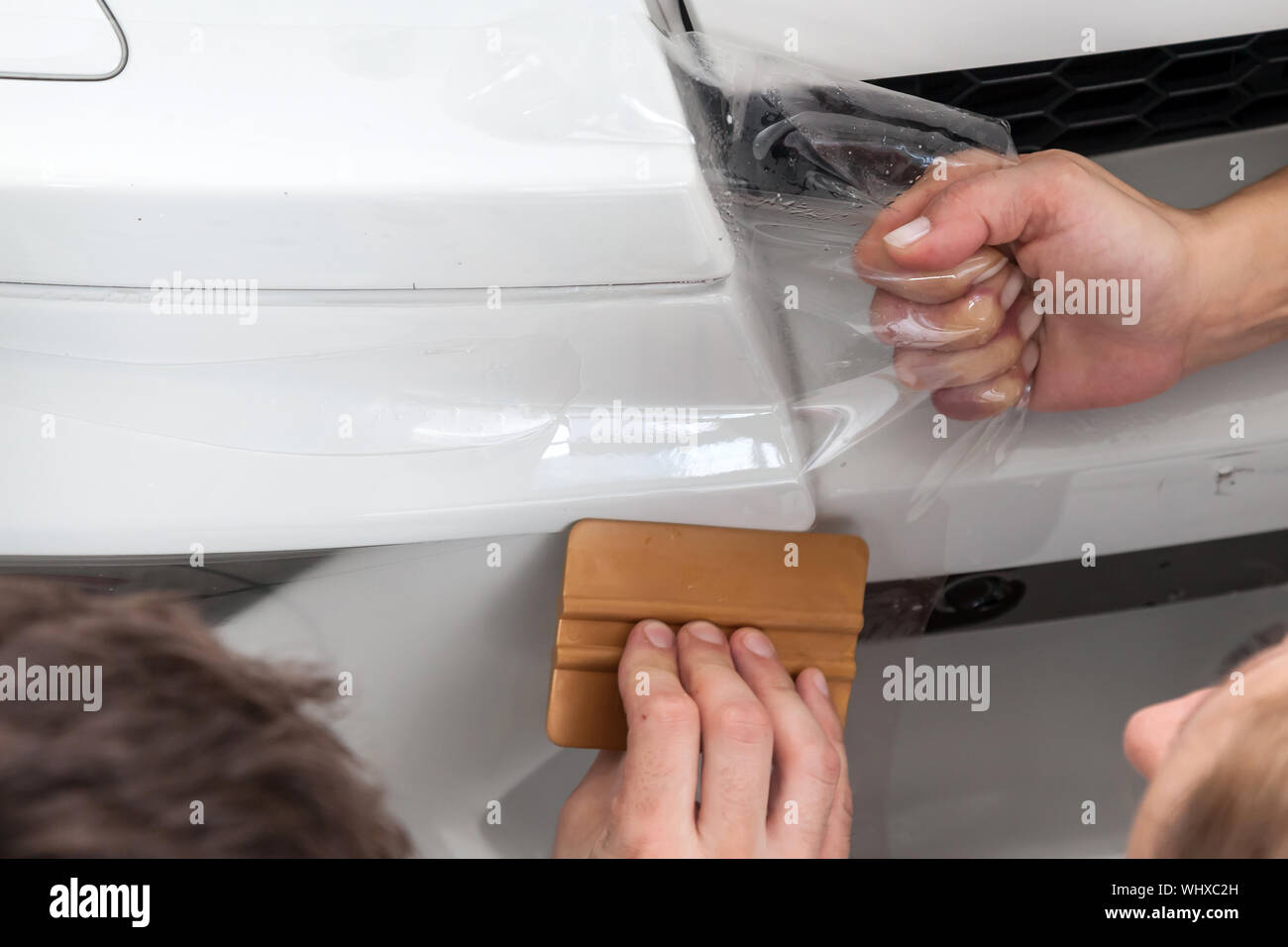Retrofitting the car with a solid transparent protective film, the ...