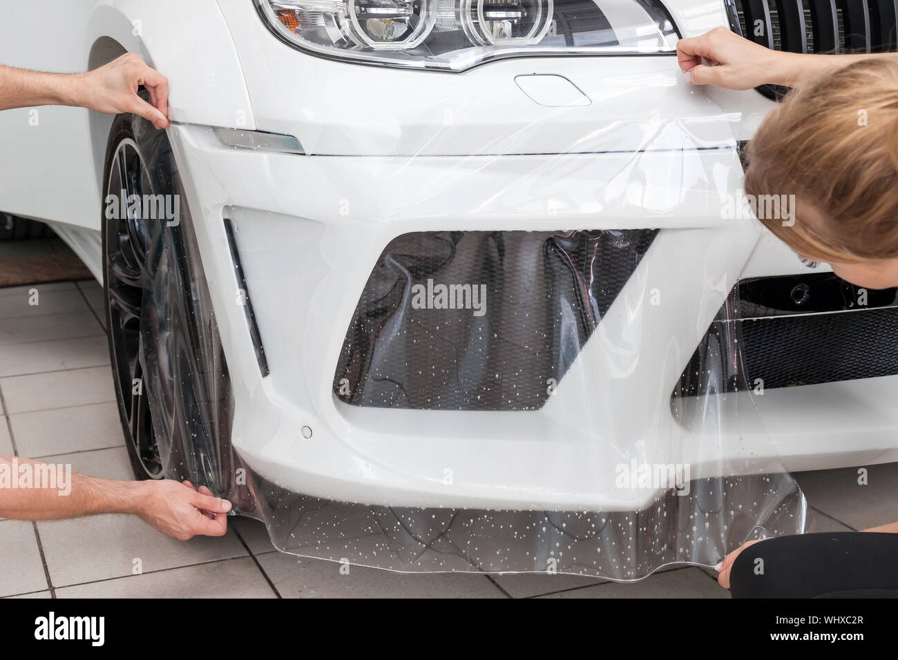 Retrofitting the car with a solid transparent protective film, the ...